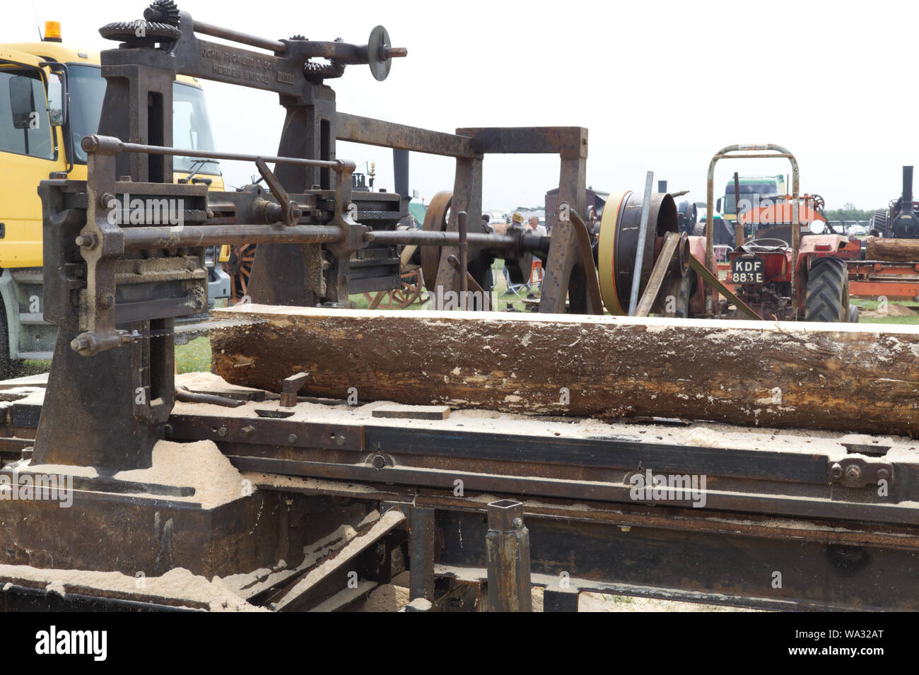 Traditional Steam Engine powered saw wood cutting trough a tree truck ...