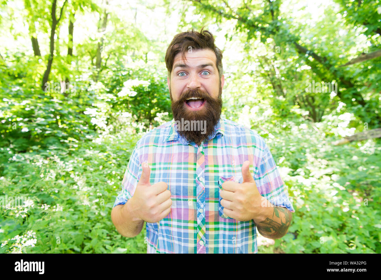 Just give a thumbs up. Happy guy gesturing thumbs ups on summer ...