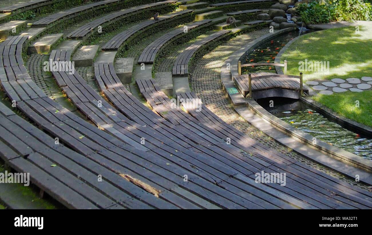 Wooden modern trendy design round circular park bench. Circular stairs ...