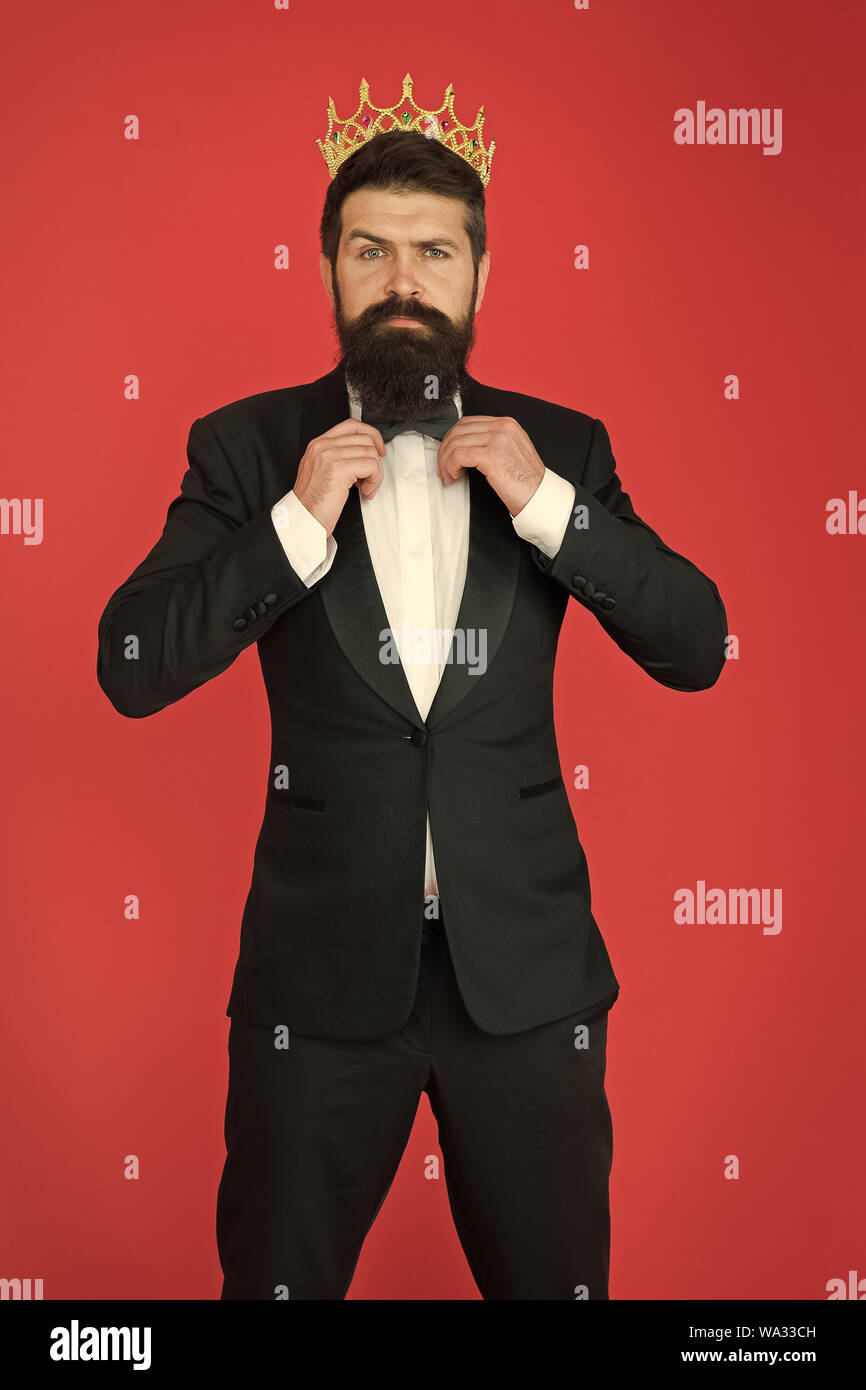 Feeling superior. Man bearded handsome guy in formal suit golden crown ...