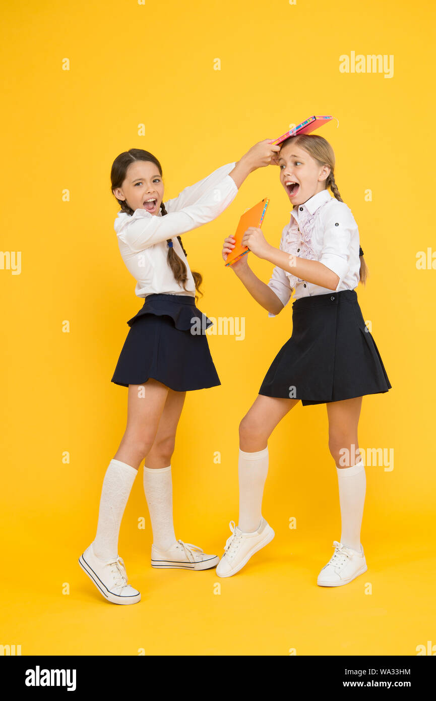schoolgirls fight. outraged classmates with workbook. girls can't share ...