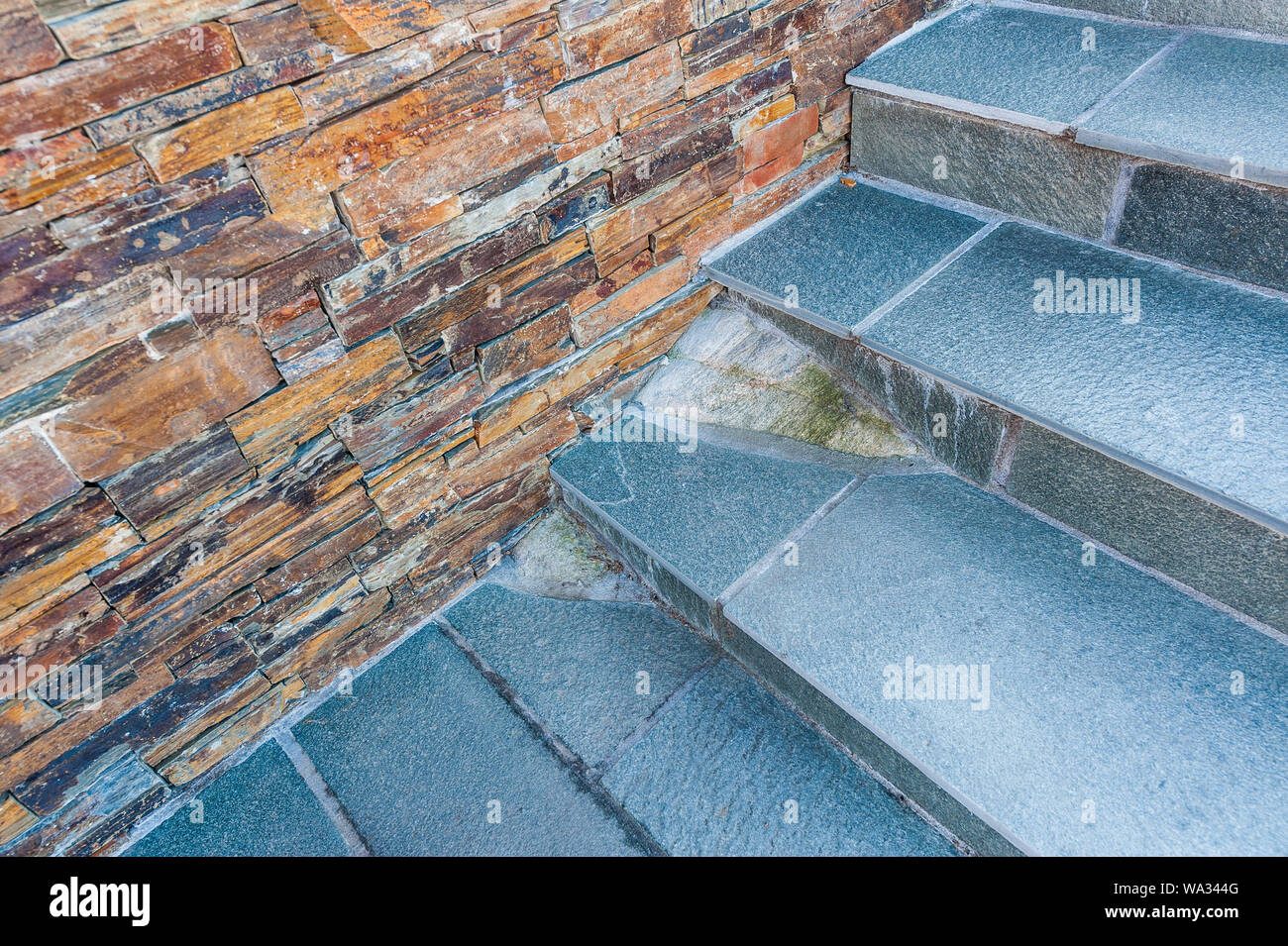 Slate stone stairs and natural stone wall Stock Photo - Alamy