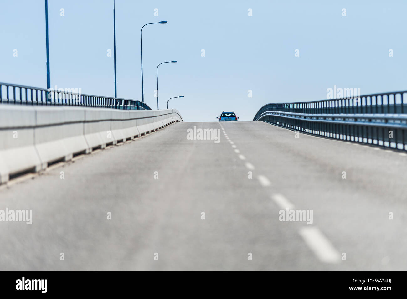 A lonesome car driving over a bridge Stock Photo - Alamy