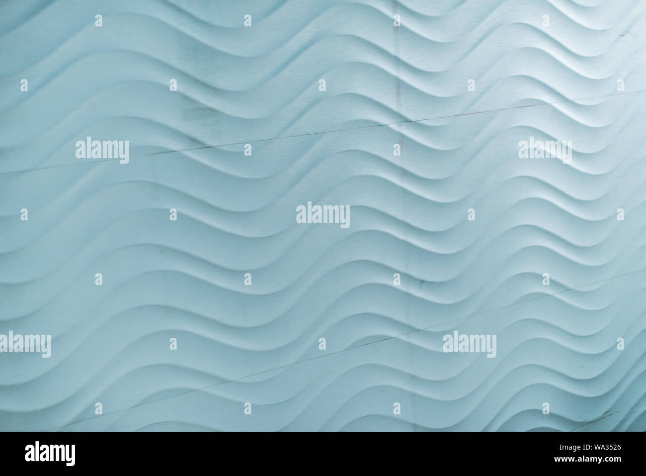 Wavy pattern on a light blue wall Stock Photo - Alamy