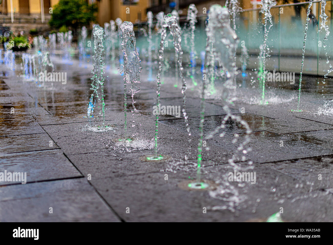 Street water fountain with green lighting Stock Photo - Alamy