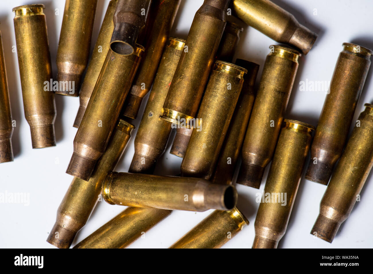 Spent rifle cartridges on white background Stock Photo - Alamy