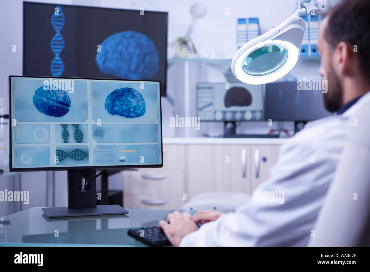 Young medical assistant working on computer in a hospital laboratory ...