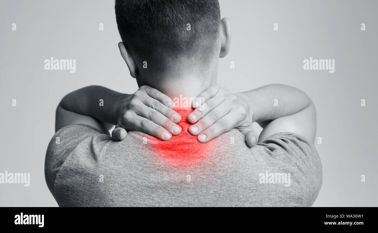 Strong man with neck pain, back view Stock Photo - Alamy