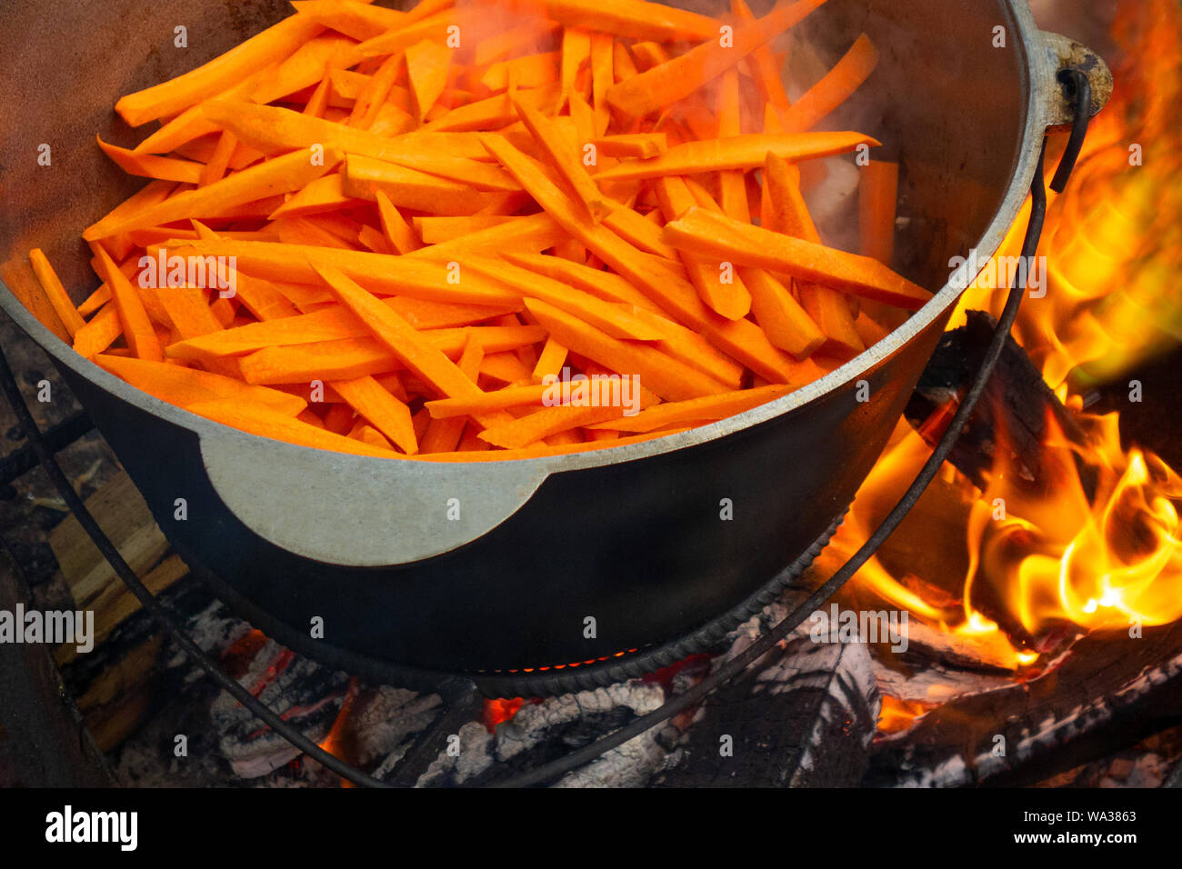 Open air kitchen at party picnic. Pilaf cooking on fire outdoor. Big ...