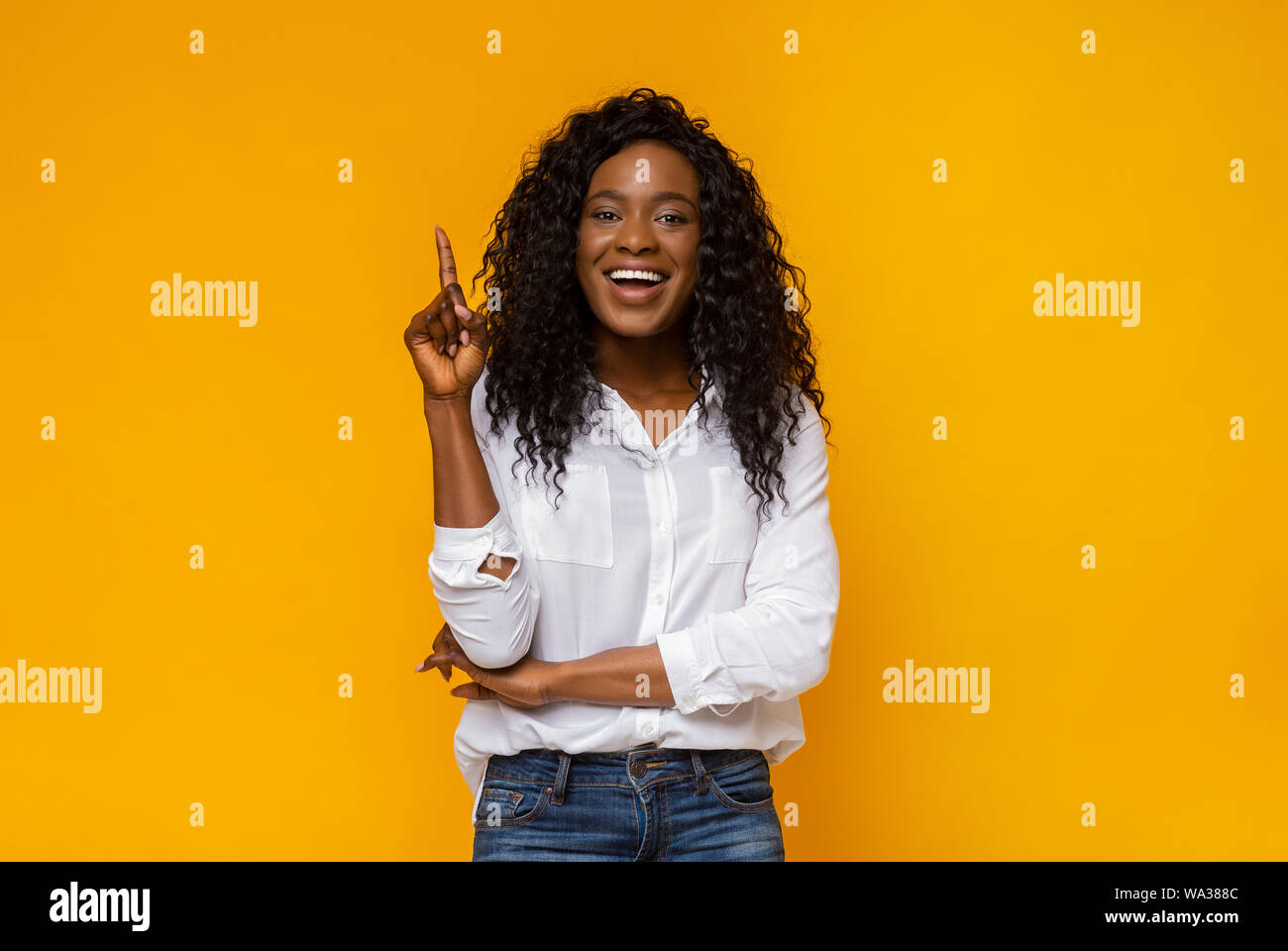Stylish young black woman pointing up on studio background Stock Photo ...