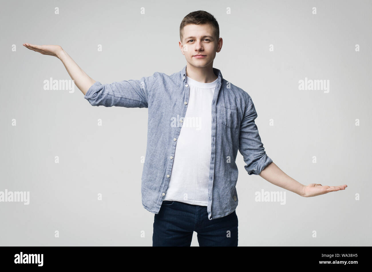 Young man making scale with his hands Stock Photo - Alamy