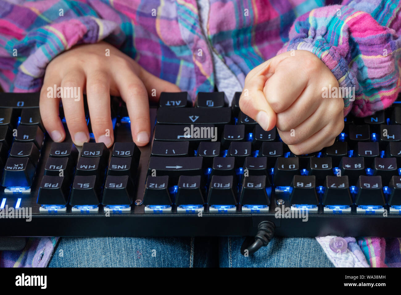 child holding a keyboard on your lap and beat it with his fist Stock ...
