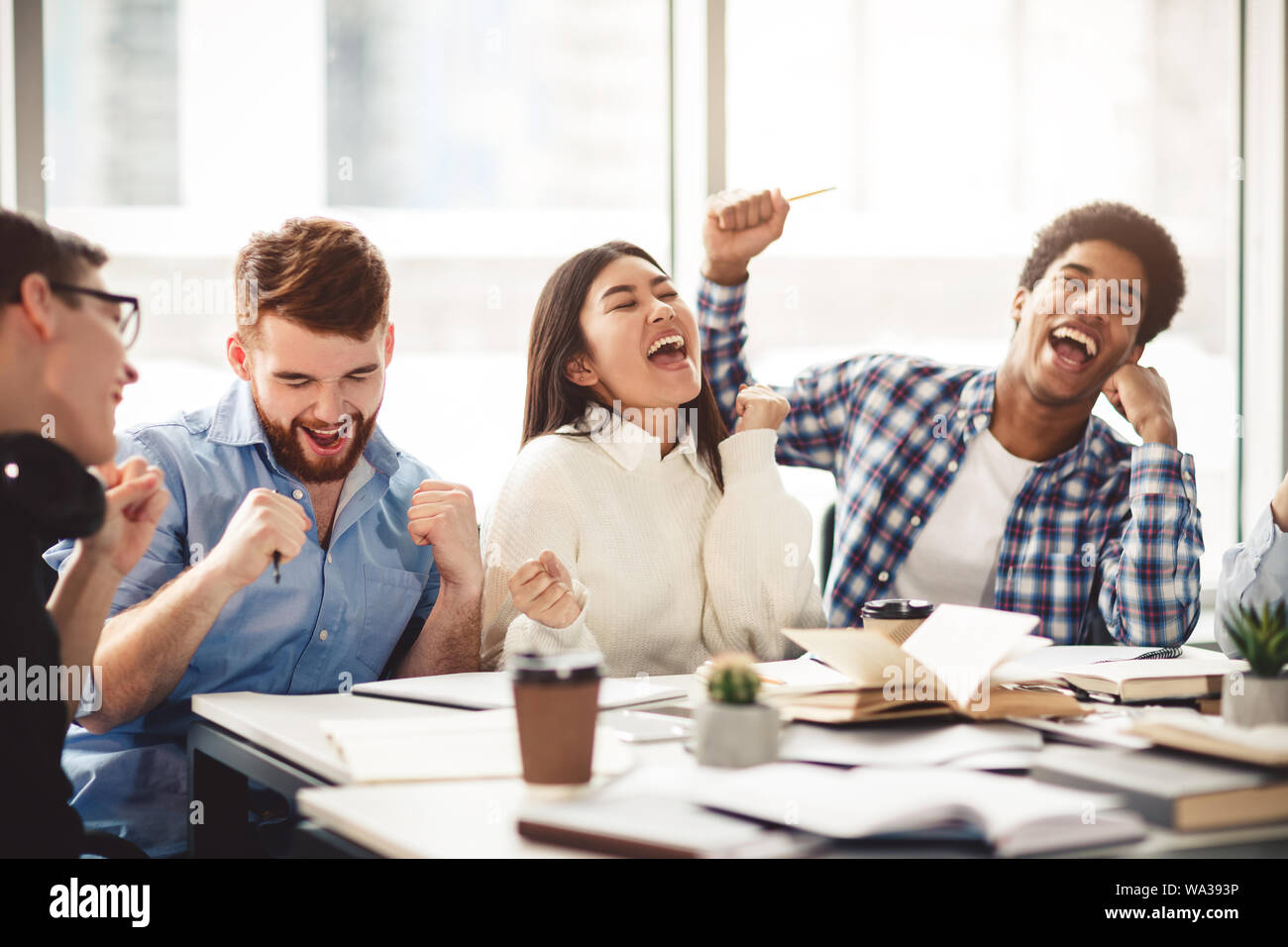 Motivated students celebrating finished learning for test Stock Photo ...