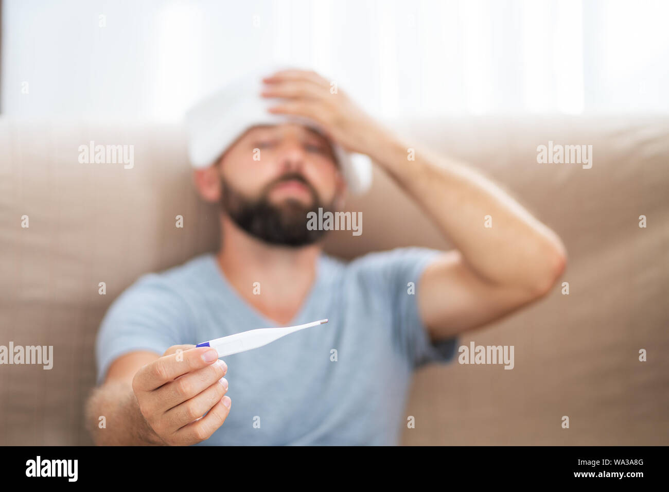 High temperature concept. Man feels badly ill. How to bring fever down ...