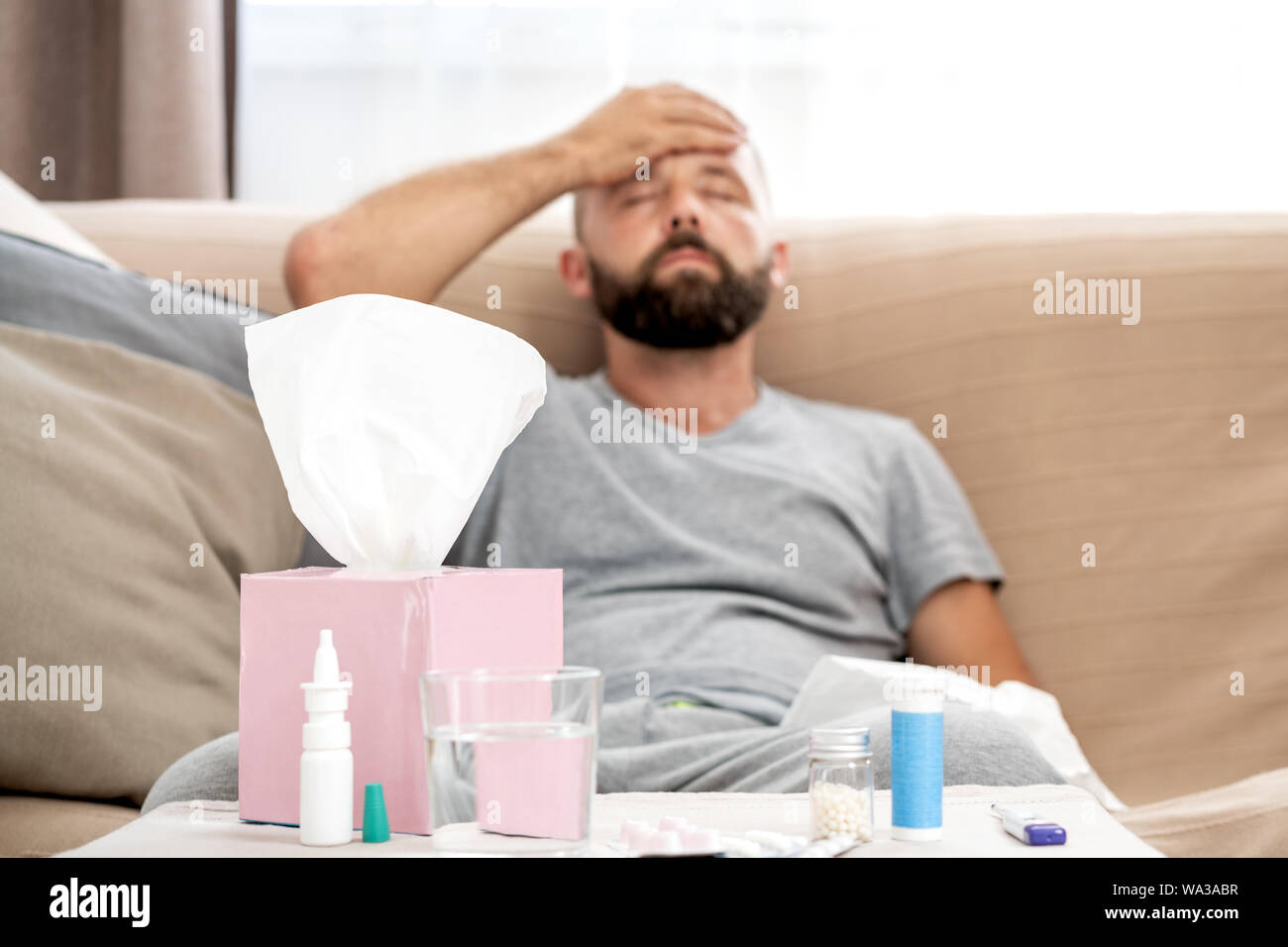 High temperature concept. Man feels badly ill. How to bring fever down ...