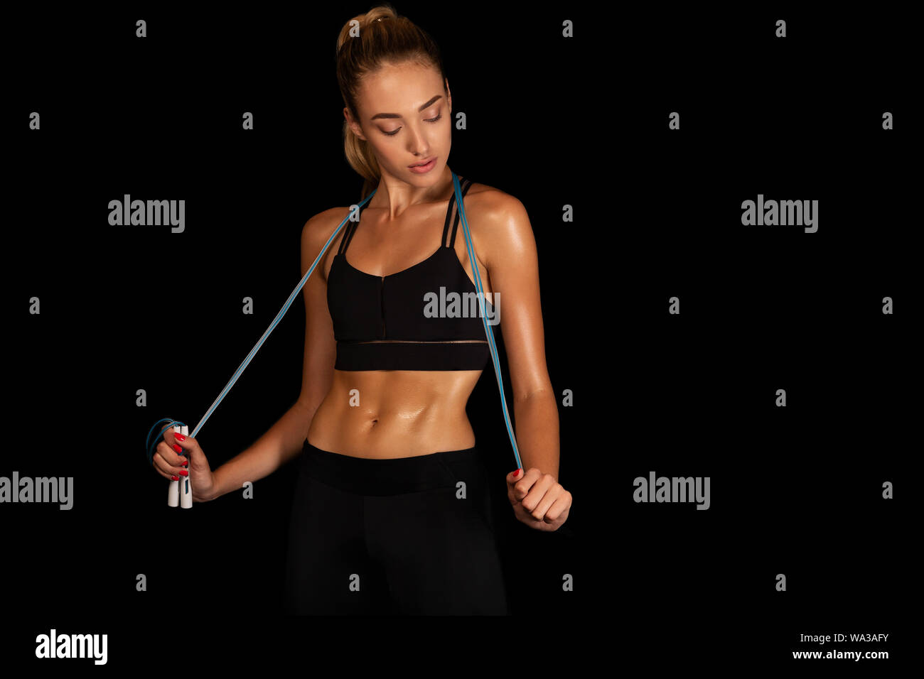 Fit Young Woman Holding Jump Rope Over Black Background Stock Photo - Alamy