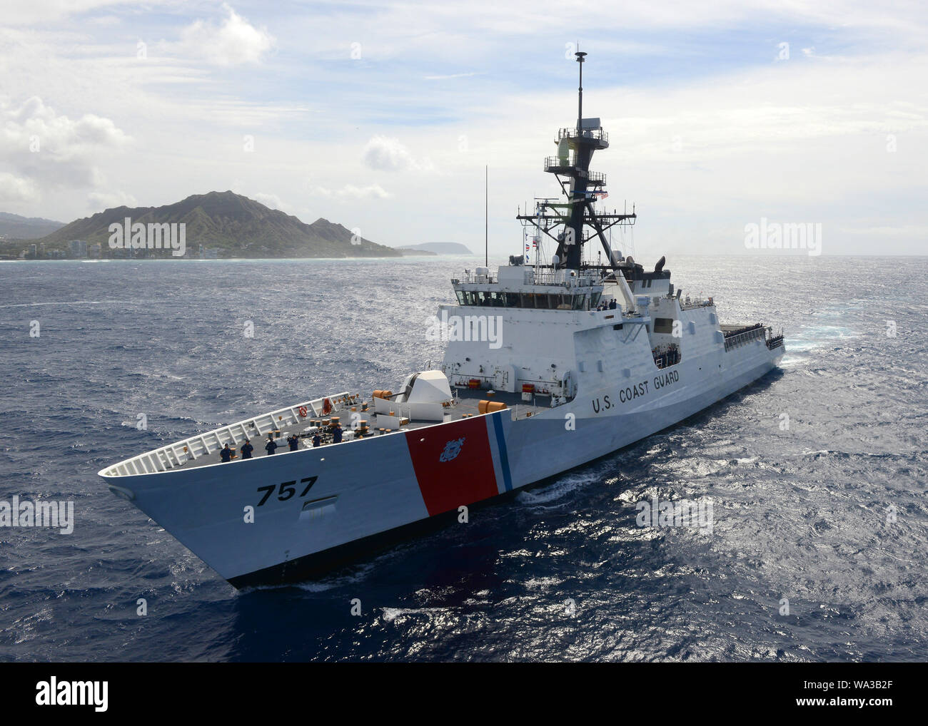 The crew of the Coast Guard Cutter Midgett (WMSL 757) transits past ...