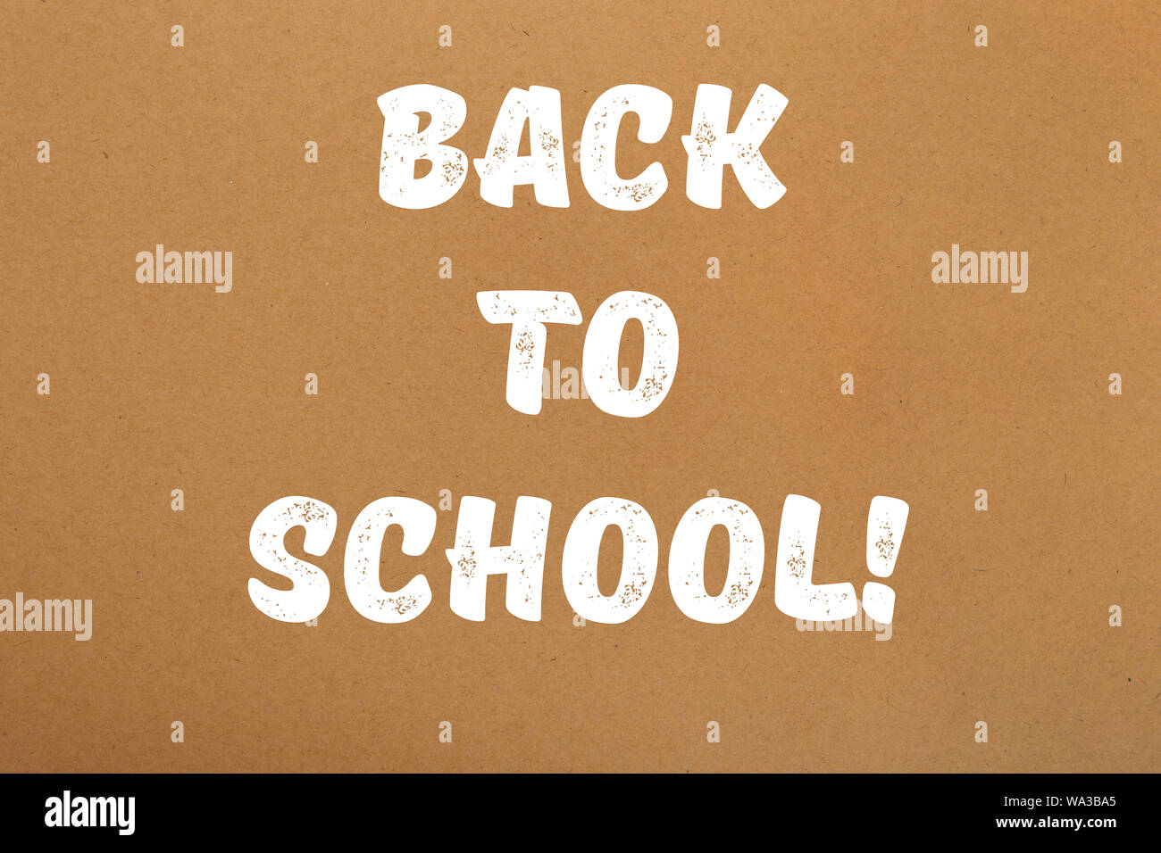 Back to school white paint handwritten sign over brown parchment paper ...