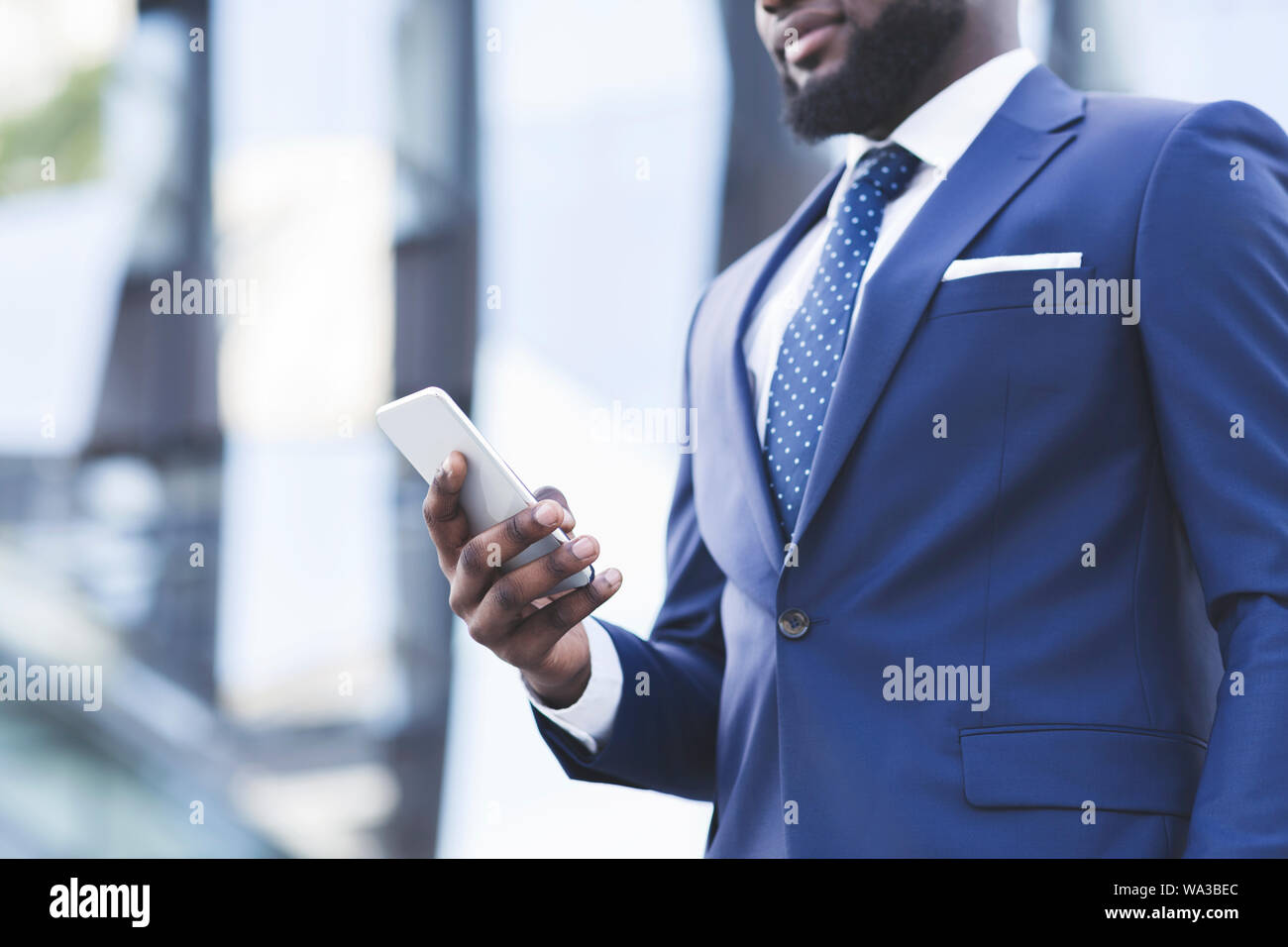 Businessman using smartphone walking hi-res stock photography and ...