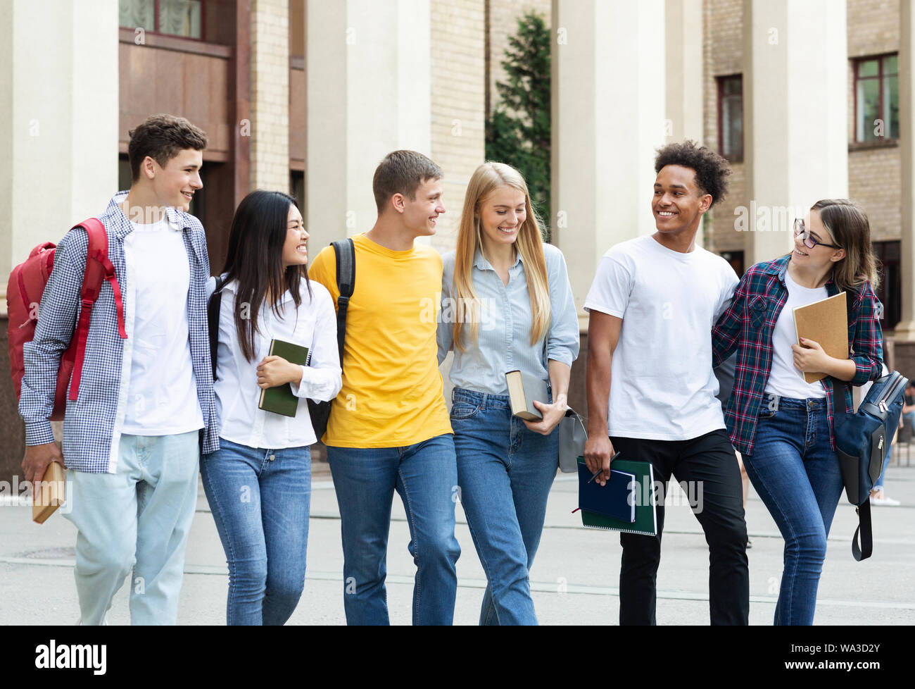 Education concept. Classmates walking in college campus Stock Photo - Alamy