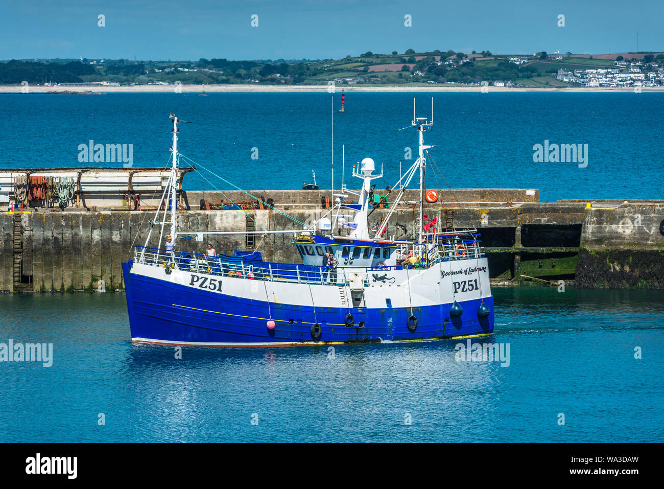 A fishing trawler returning with its catch to the harbour at Newlyn ...