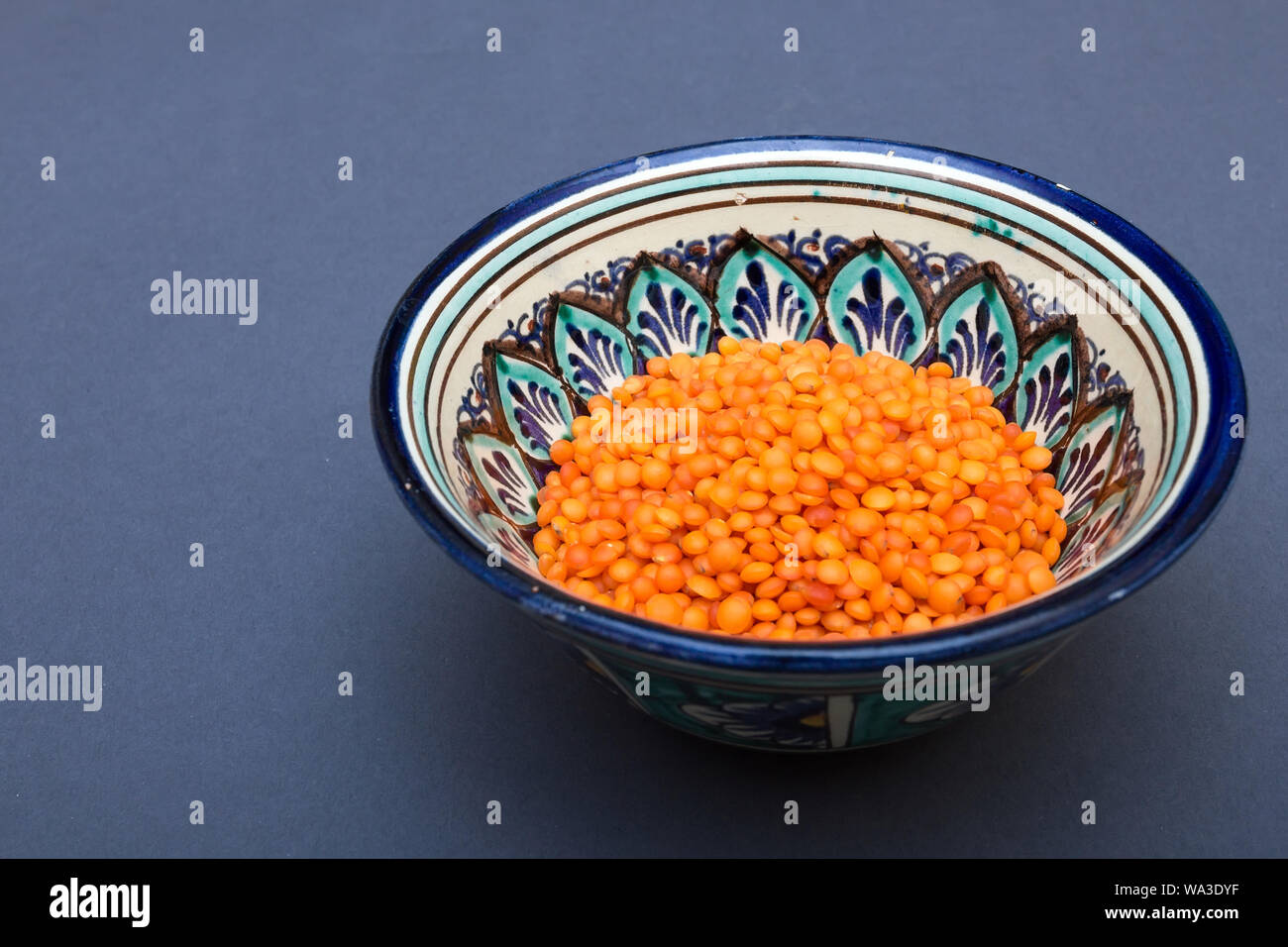 Orange lentils in a colored clay cup Stock Photo - Alamy