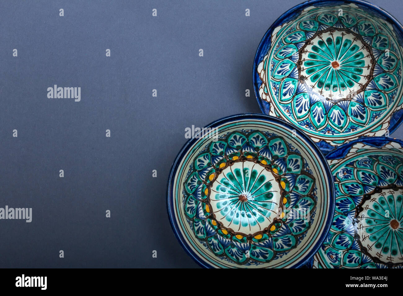 Ethnic Uzbek ceramic tableware on the gray background. Decorative ...