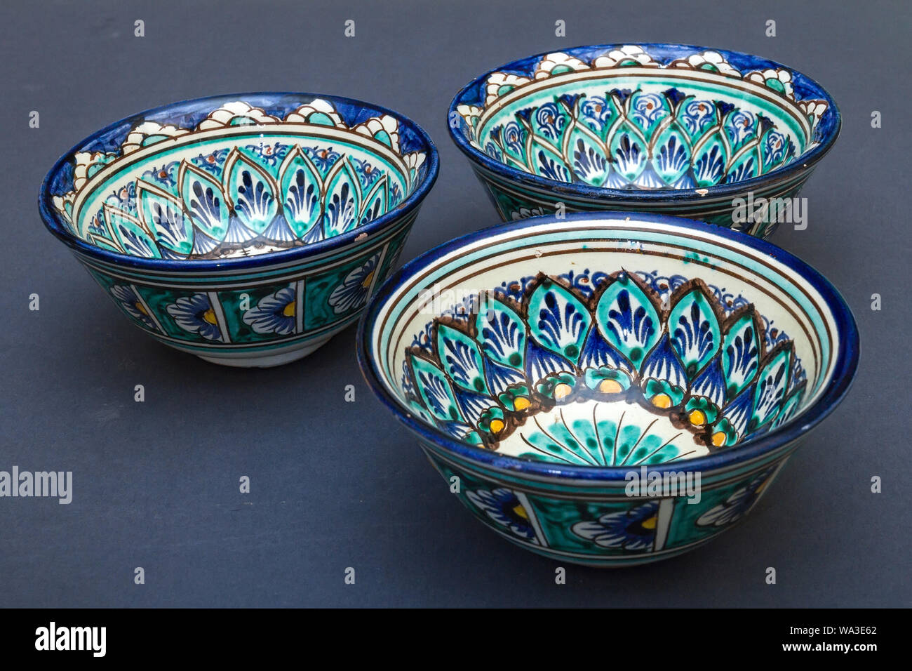 Ethnic Uzbek ceramic tableware on the gray background. Decorative ...