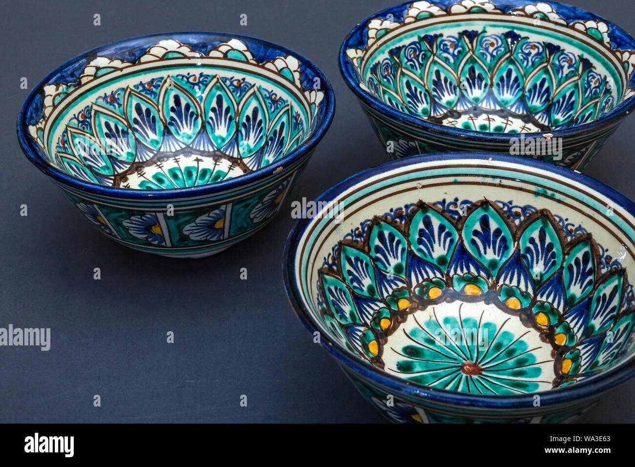 Ethnic Uzbek ceramic tableware on the gray background. Decorative ...