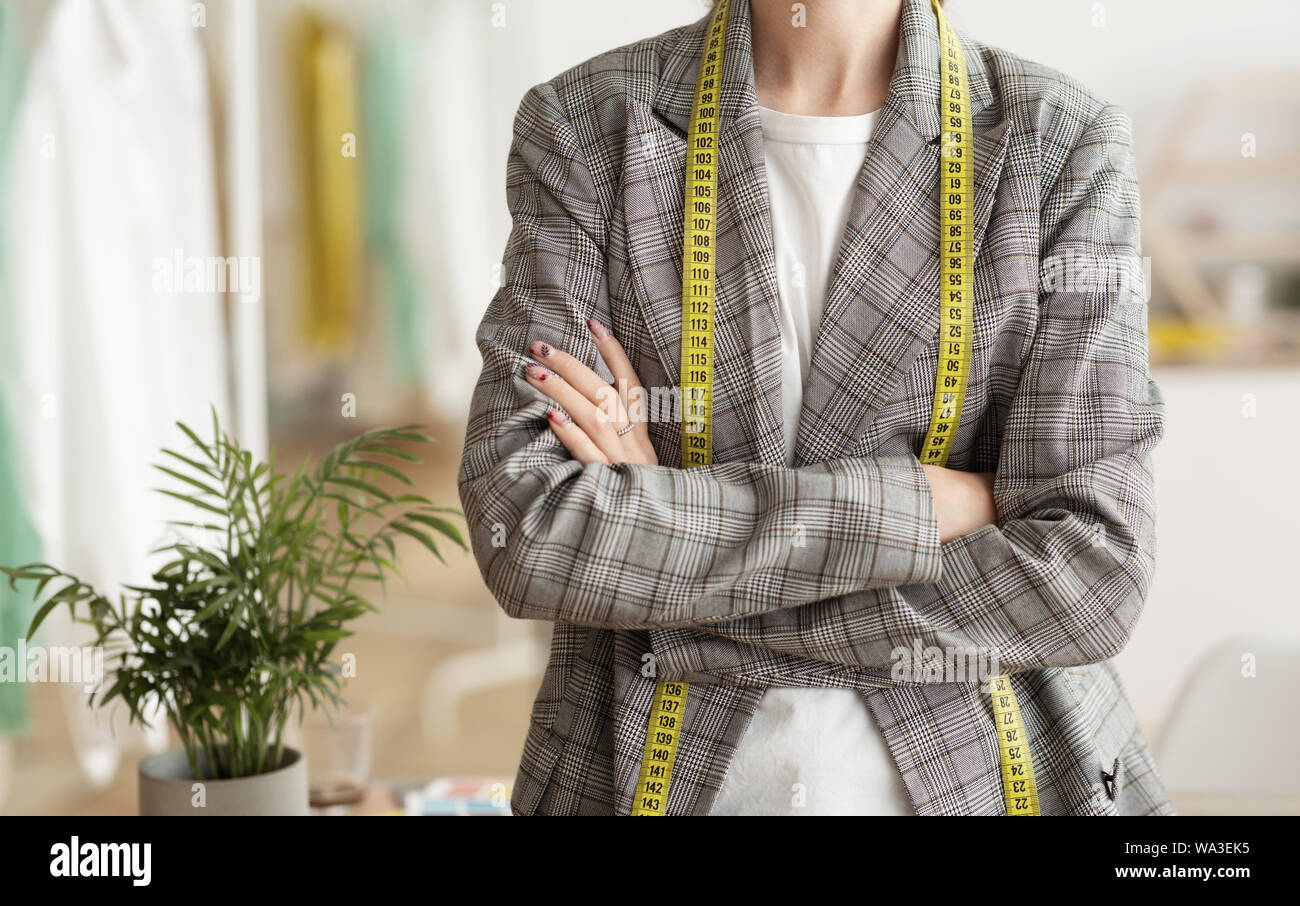 Female fashion designer with arms crossed in design studio Stock Photo ...