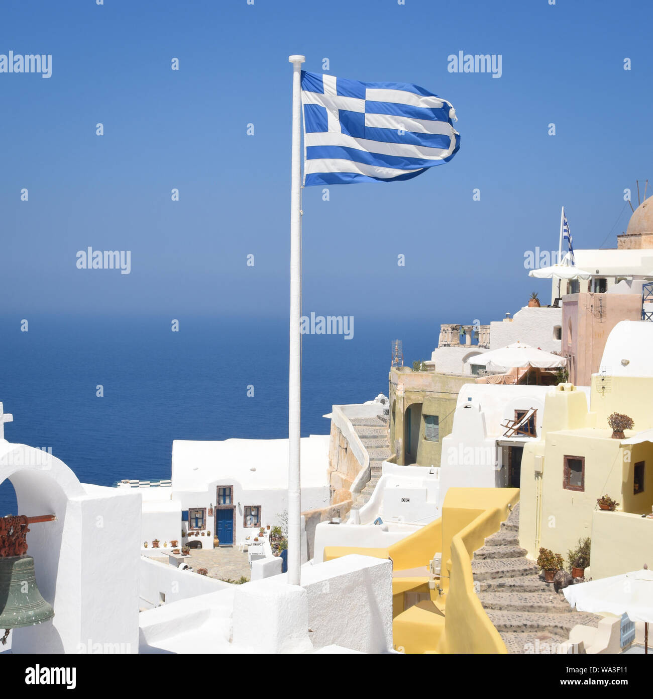 greek flag flying over santorini Stock Photo - Alamy