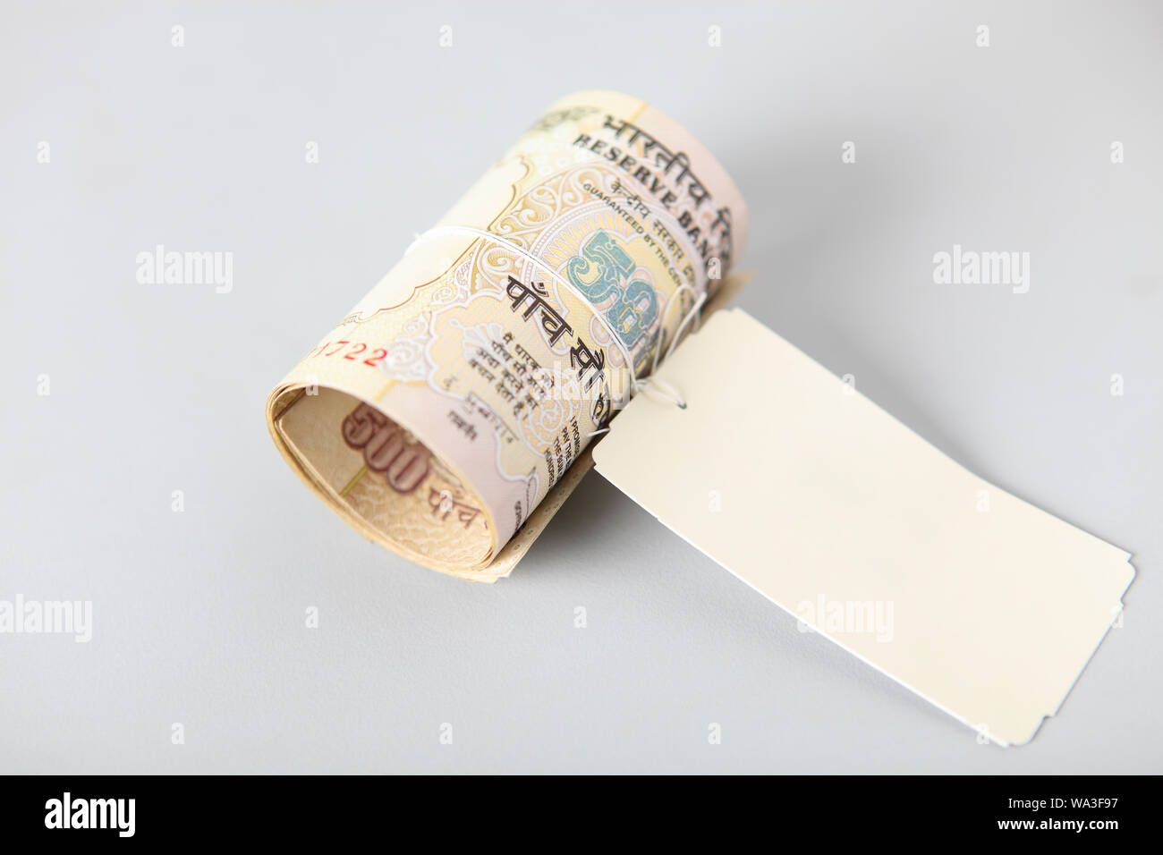 Money roll of five hundred rupees note with a blank tag Stock Photo - Alamy