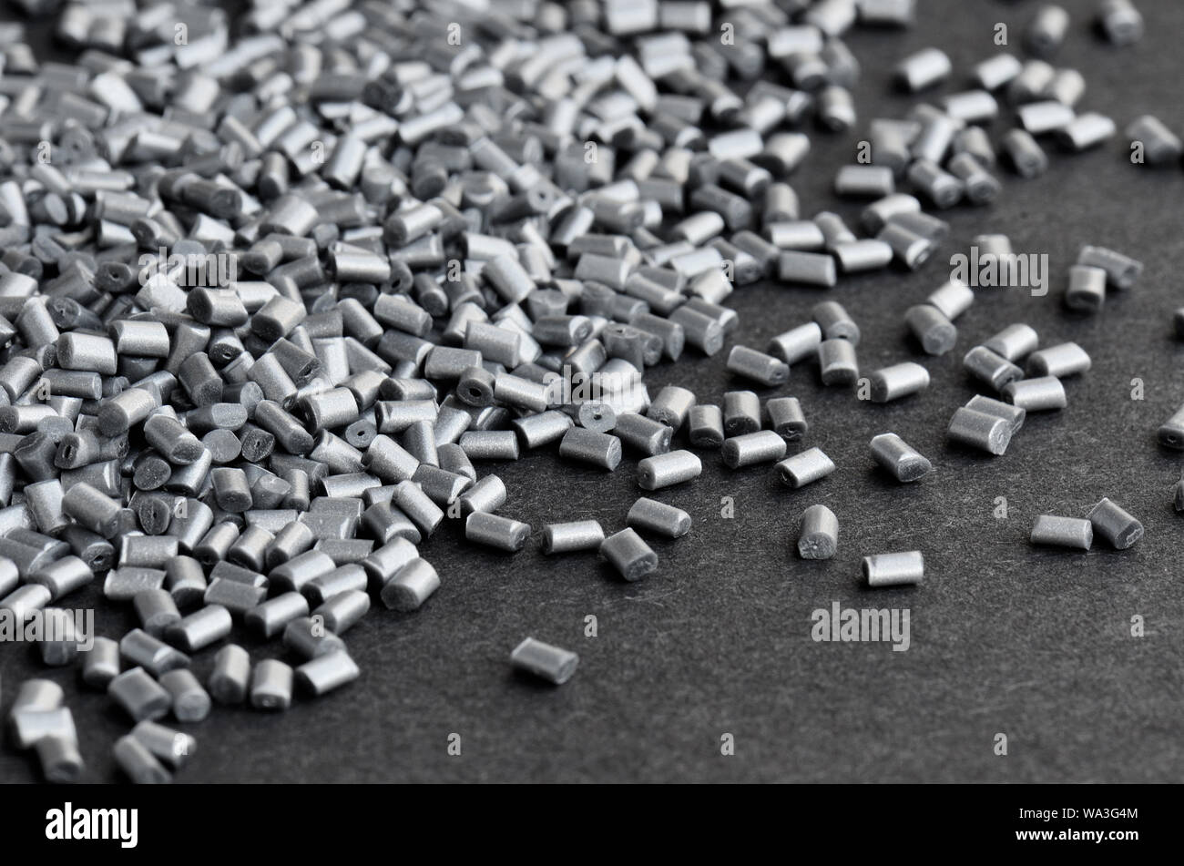 silver metallic polymer resin on grey background Stock Photo - Alamy