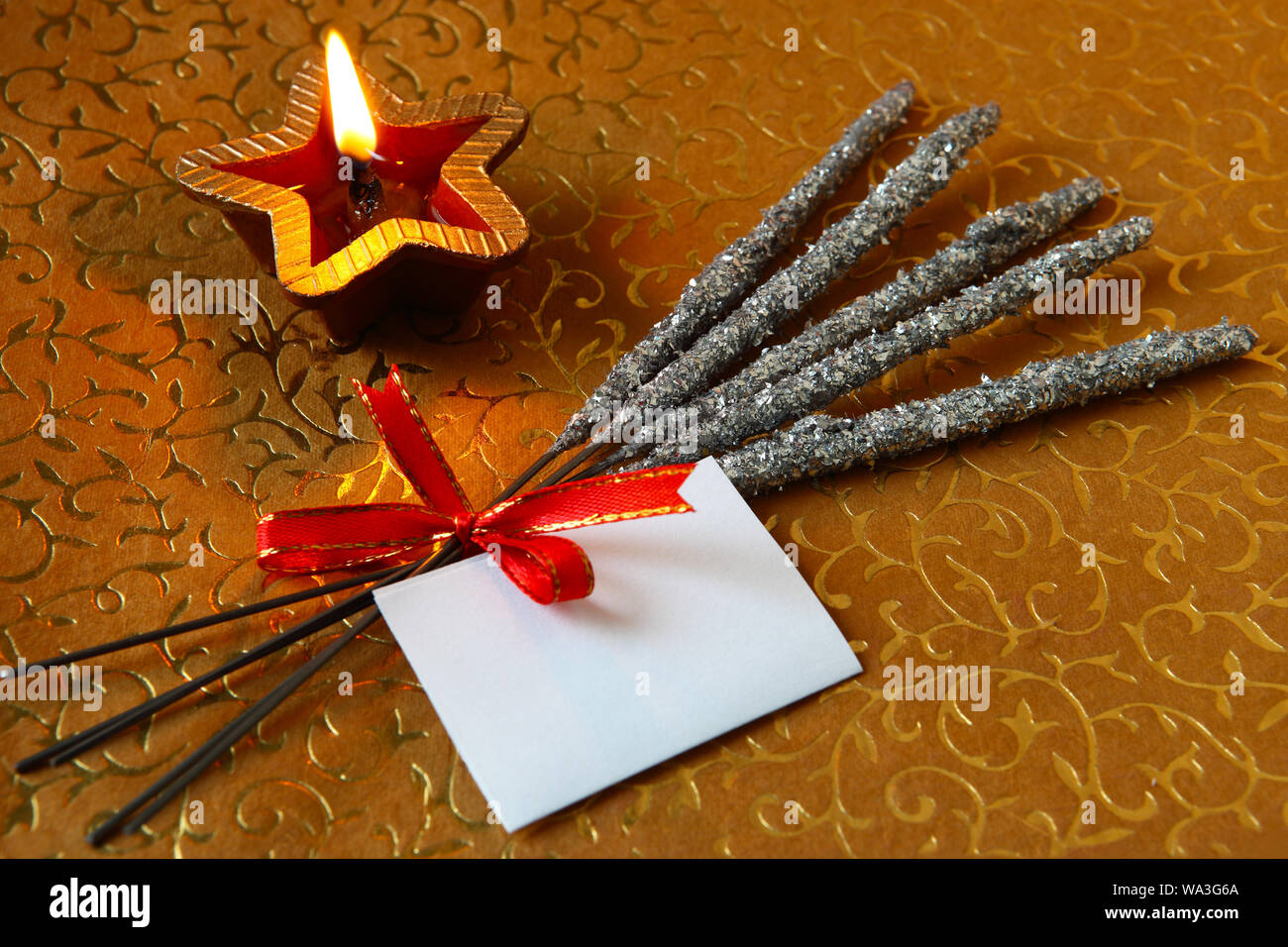 Phooljhadi and diya with a blank card isolated on yellow background ...