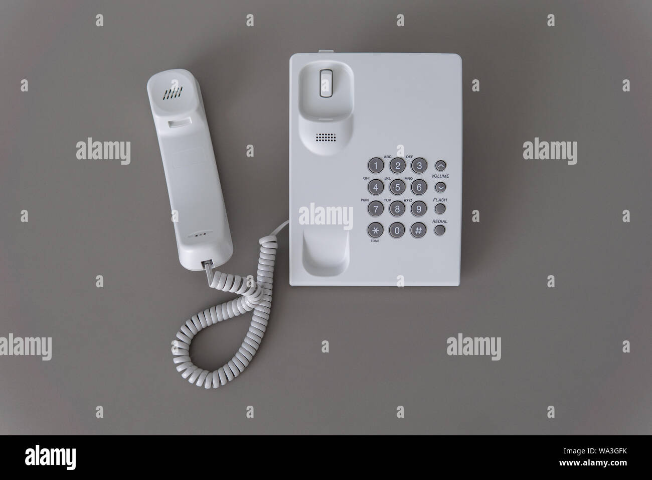Modern white landline office phone with a hook. Technical support ...