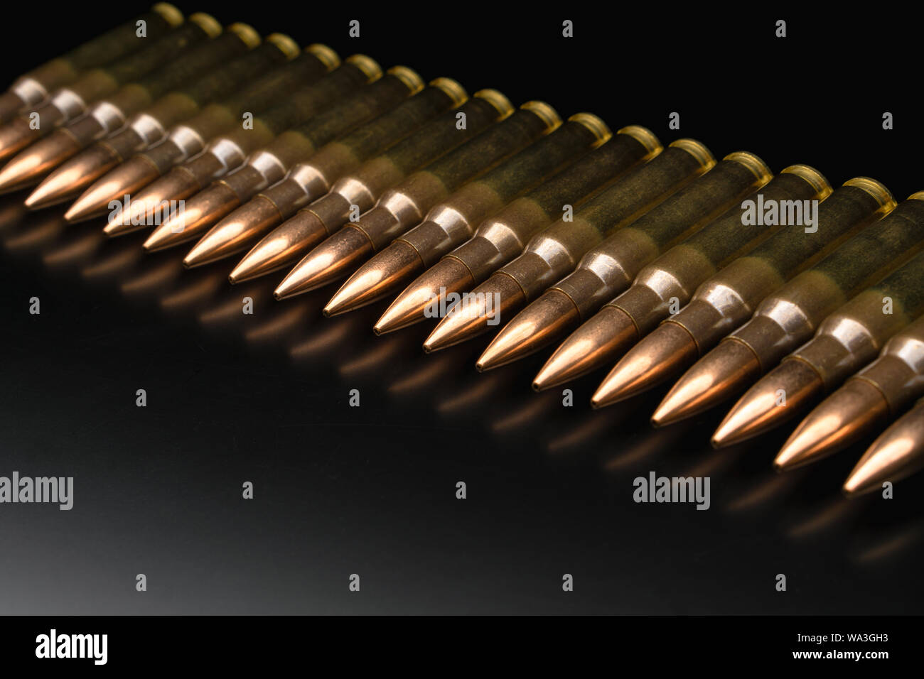 Bullet isolated on black background with reflexion. Rifle bullets close ...