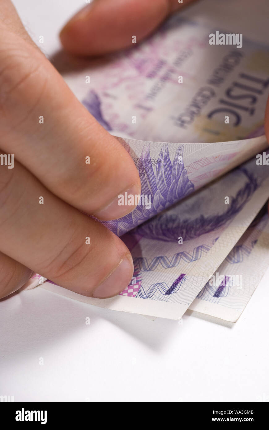 hand of a man counting banknotes of one thousand Czech crown Stock ...