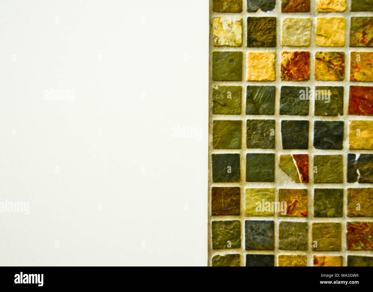 view of some tiles on a bathroom wall from above, white and coloured ...