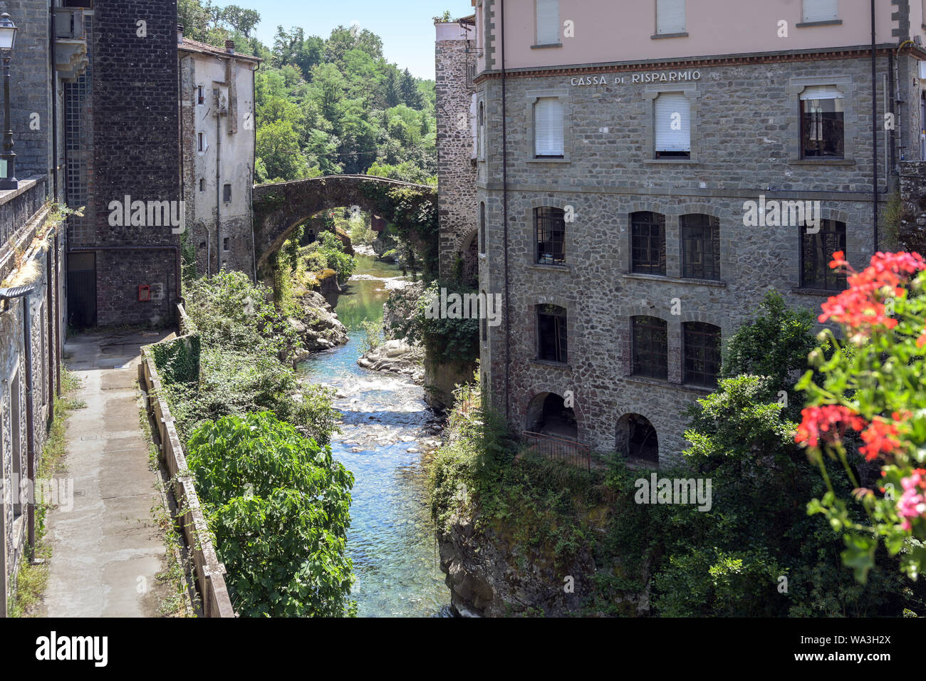 Magra River with the ancient bridge between the houses of Bagnone, a ...