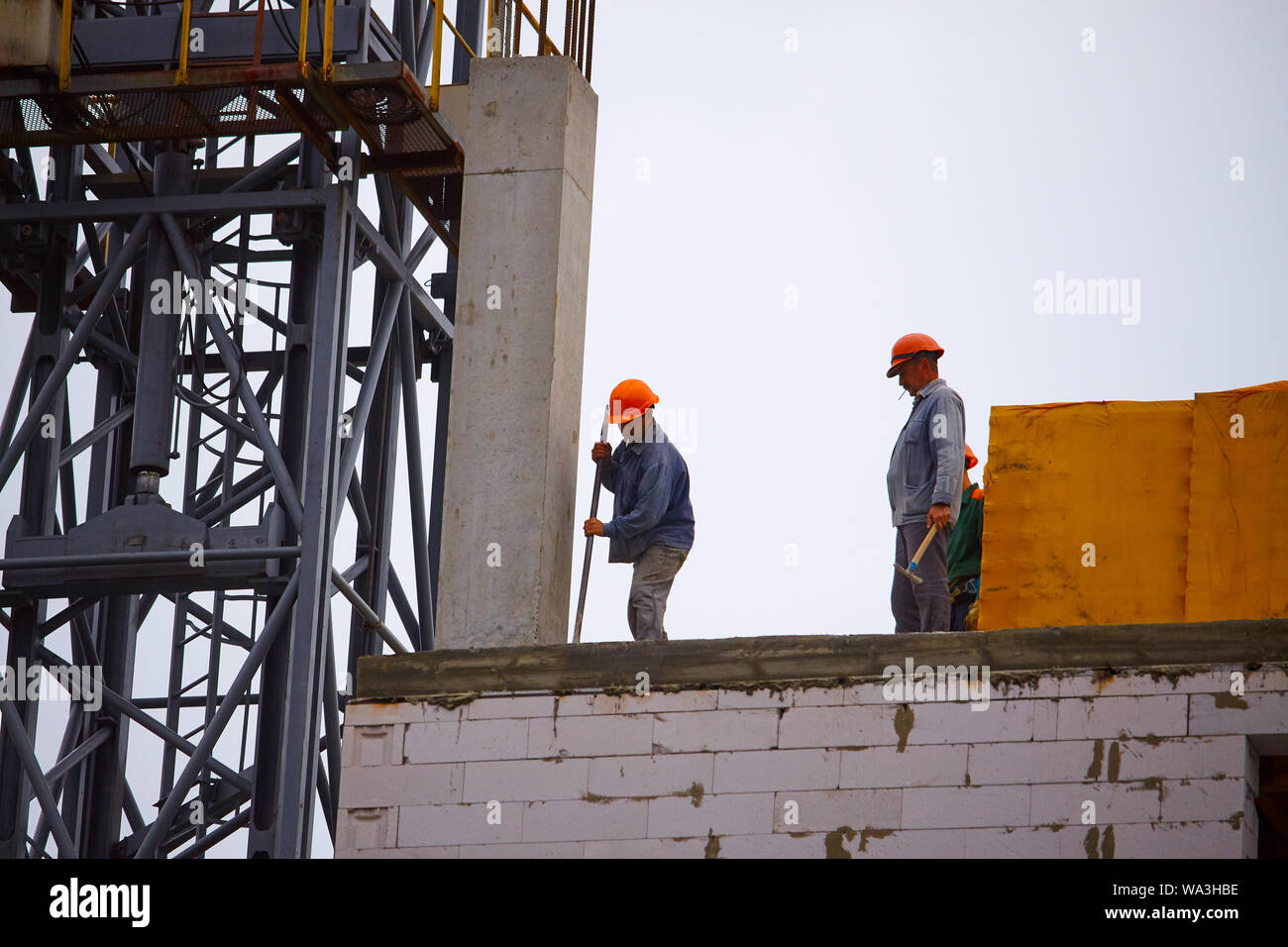 Kharkiv, Ukraine - August 02, 2019: Male builders work on the ...