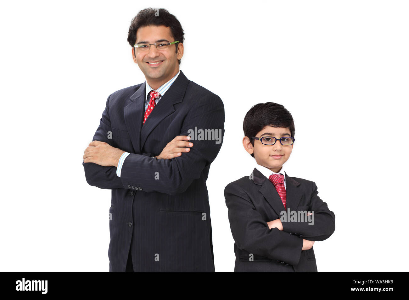 Boy imitating as a businessman and standing with his father Stock Photo ...