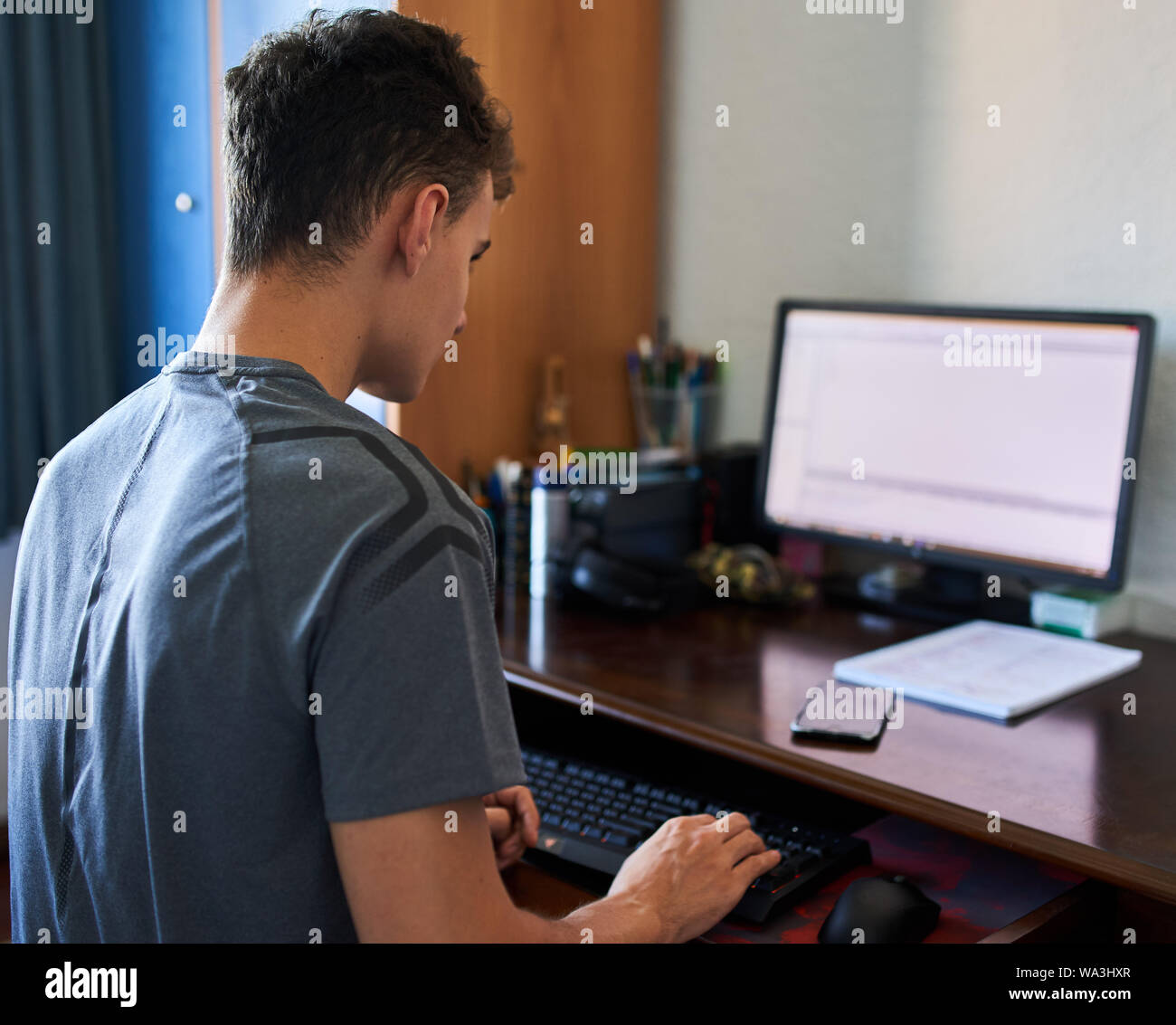Student at his desk doing homework Stock Photo - Alamy