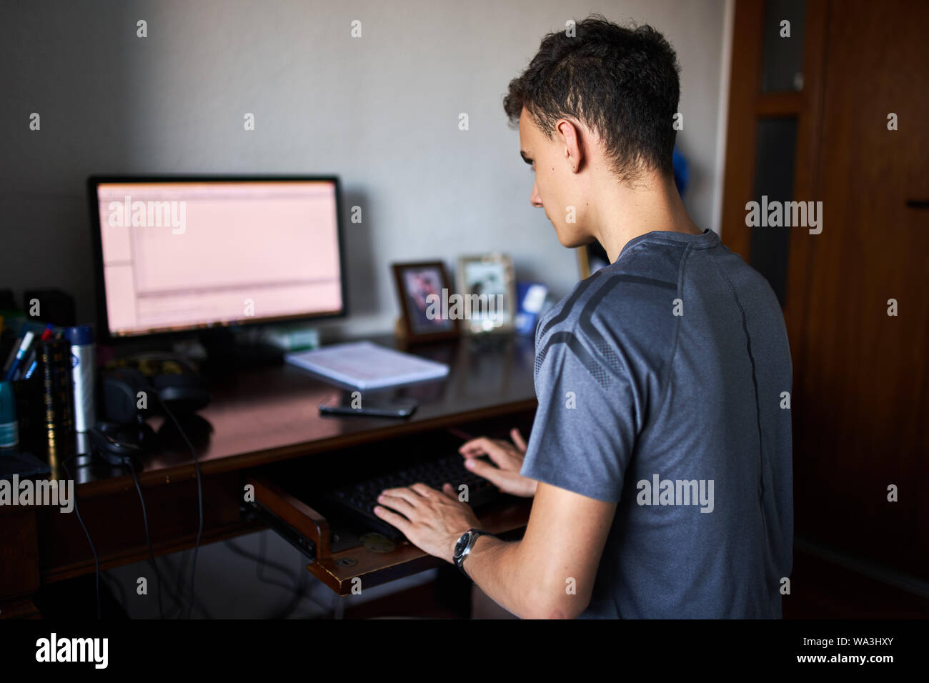 Student at his desk doing homework Stock Photo - Alamy