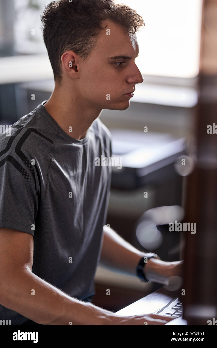 Student at his desk doing homework Stock Photo - Alamy