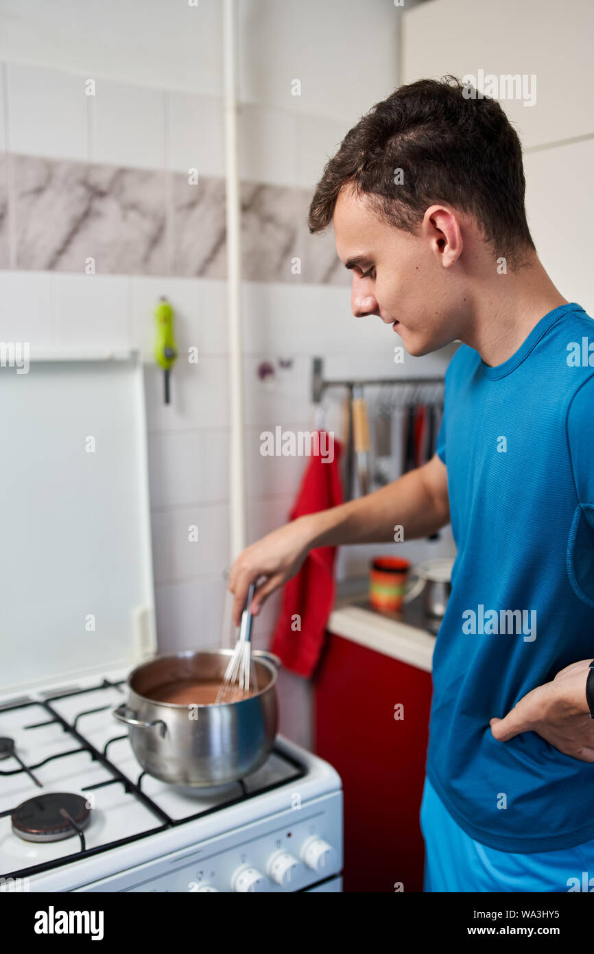 Male cooking teen hi-res stock photography and images - Alamy