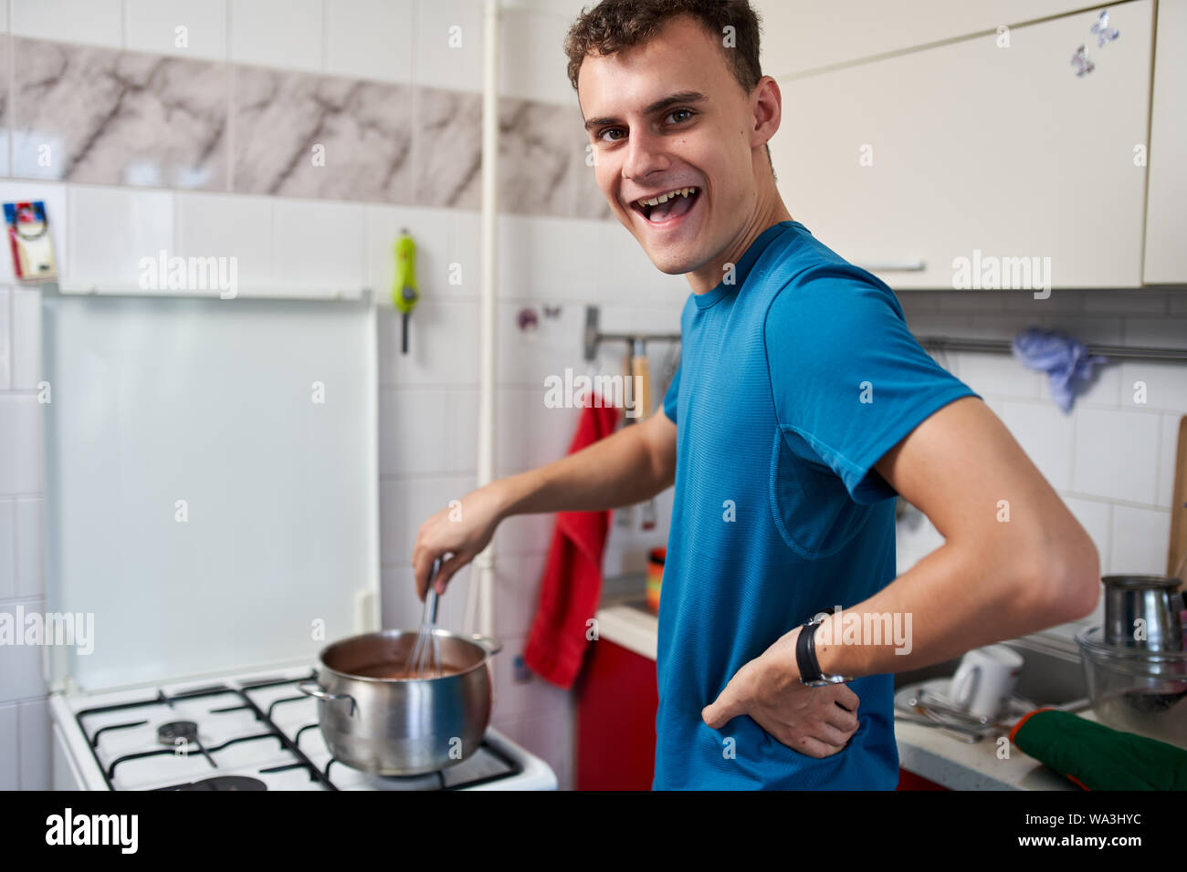 Young man cooking Stock Photo - Alamy