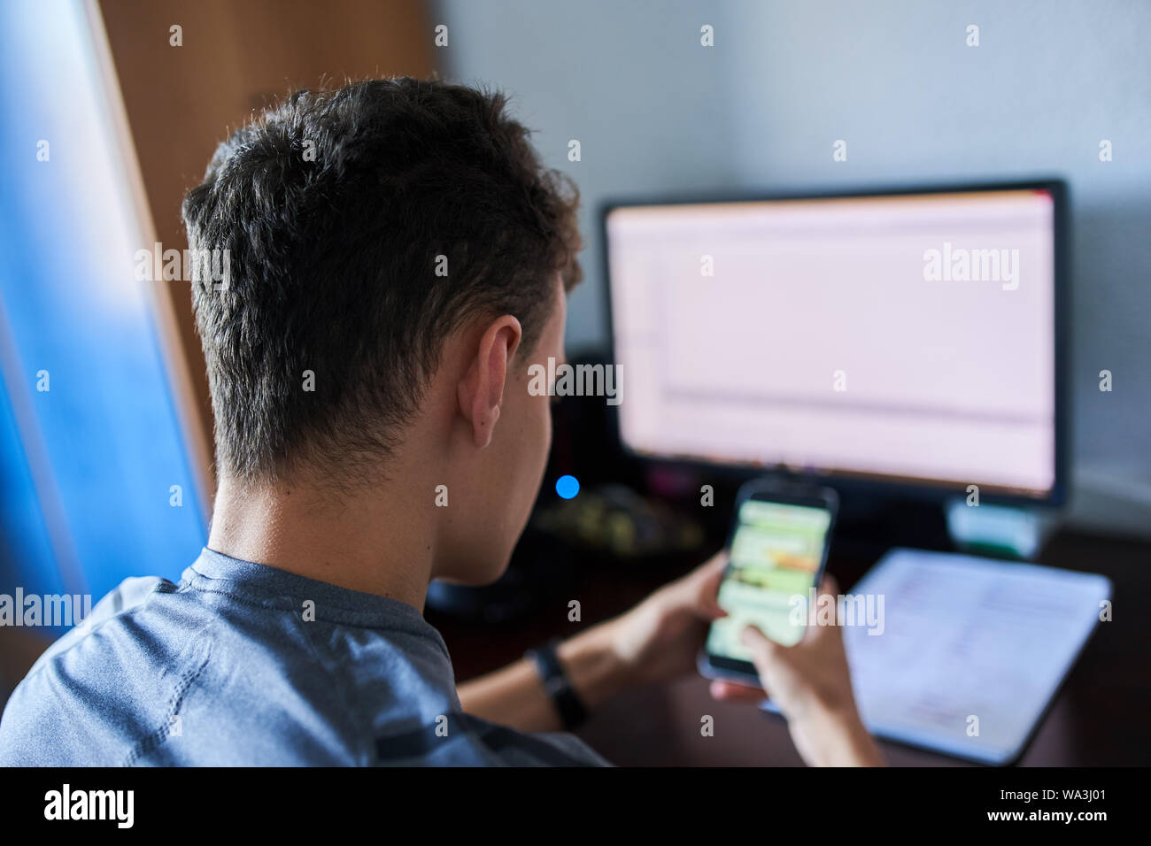 Student at his desk doing homework Stock Photo - Alamy