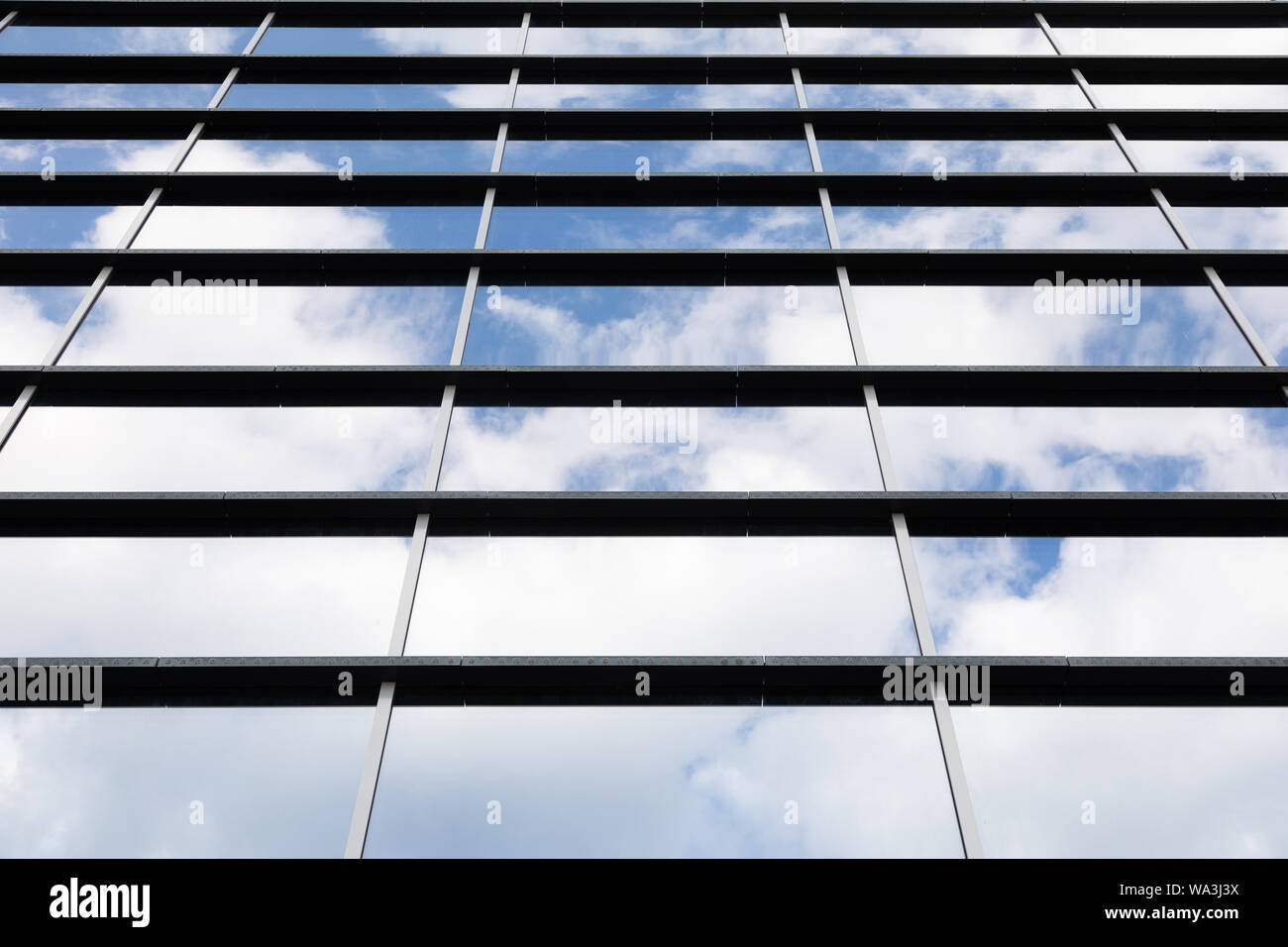 Bottom view of tall modern glass building Stock Photo - Alamy