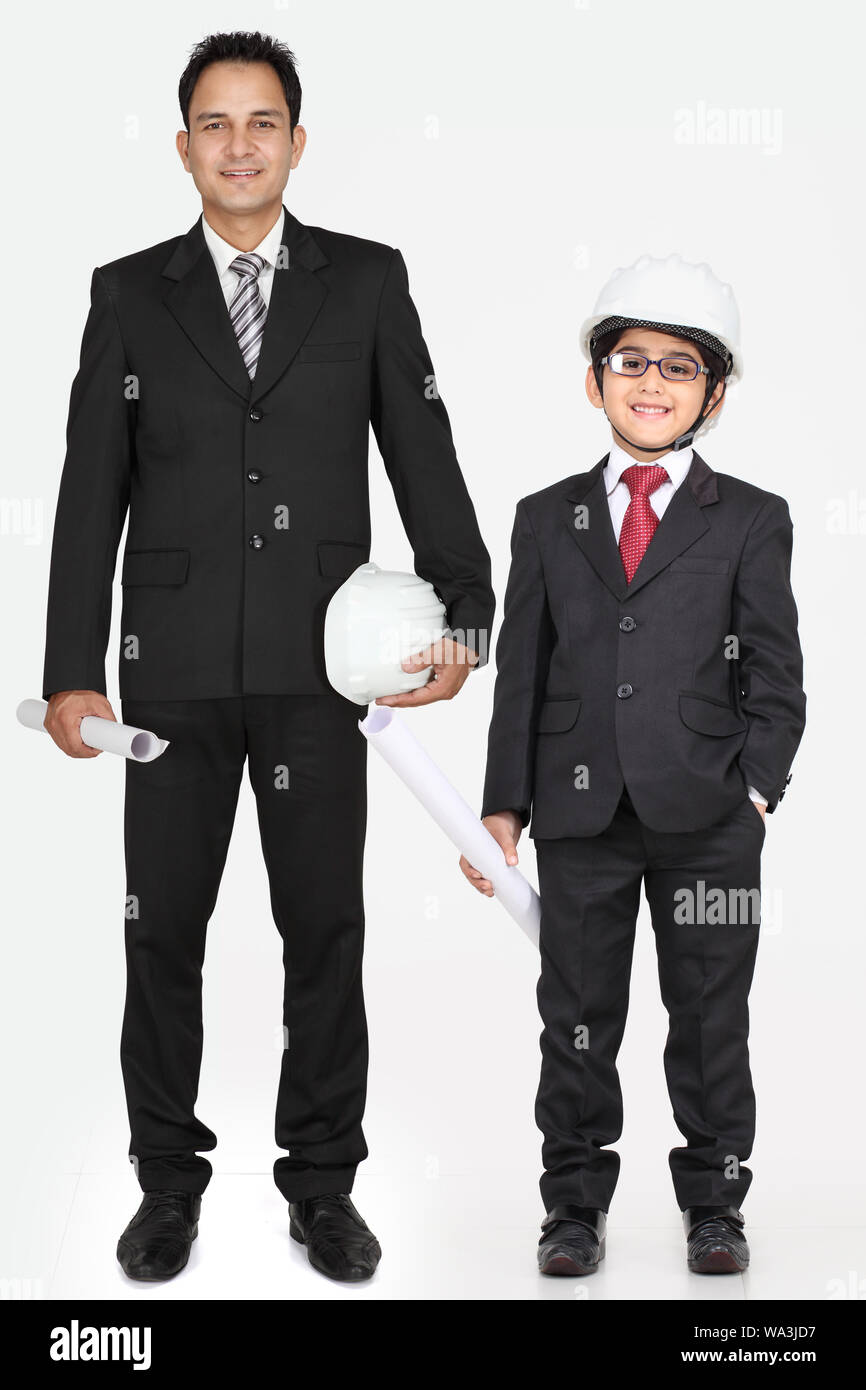 Boy imitating as architect and standing with his father Stock Photo - Alamy