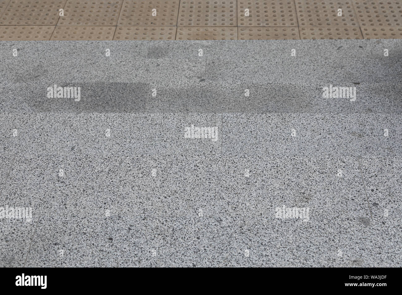 Gray granite tile with tactile paving Stock Photo - Alamy